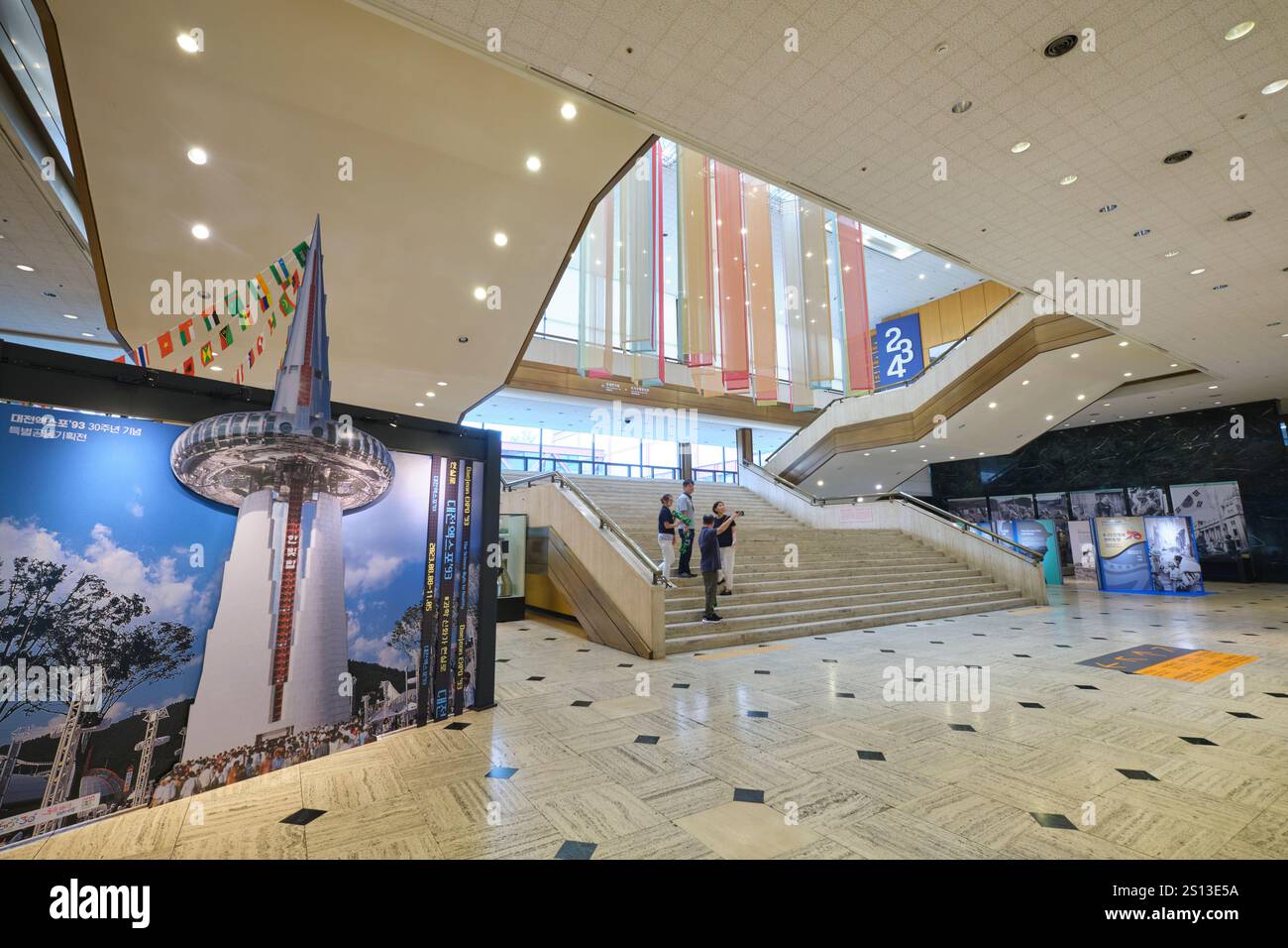 View of the front entrance lobby with big, grand staircase, steps. At ...
