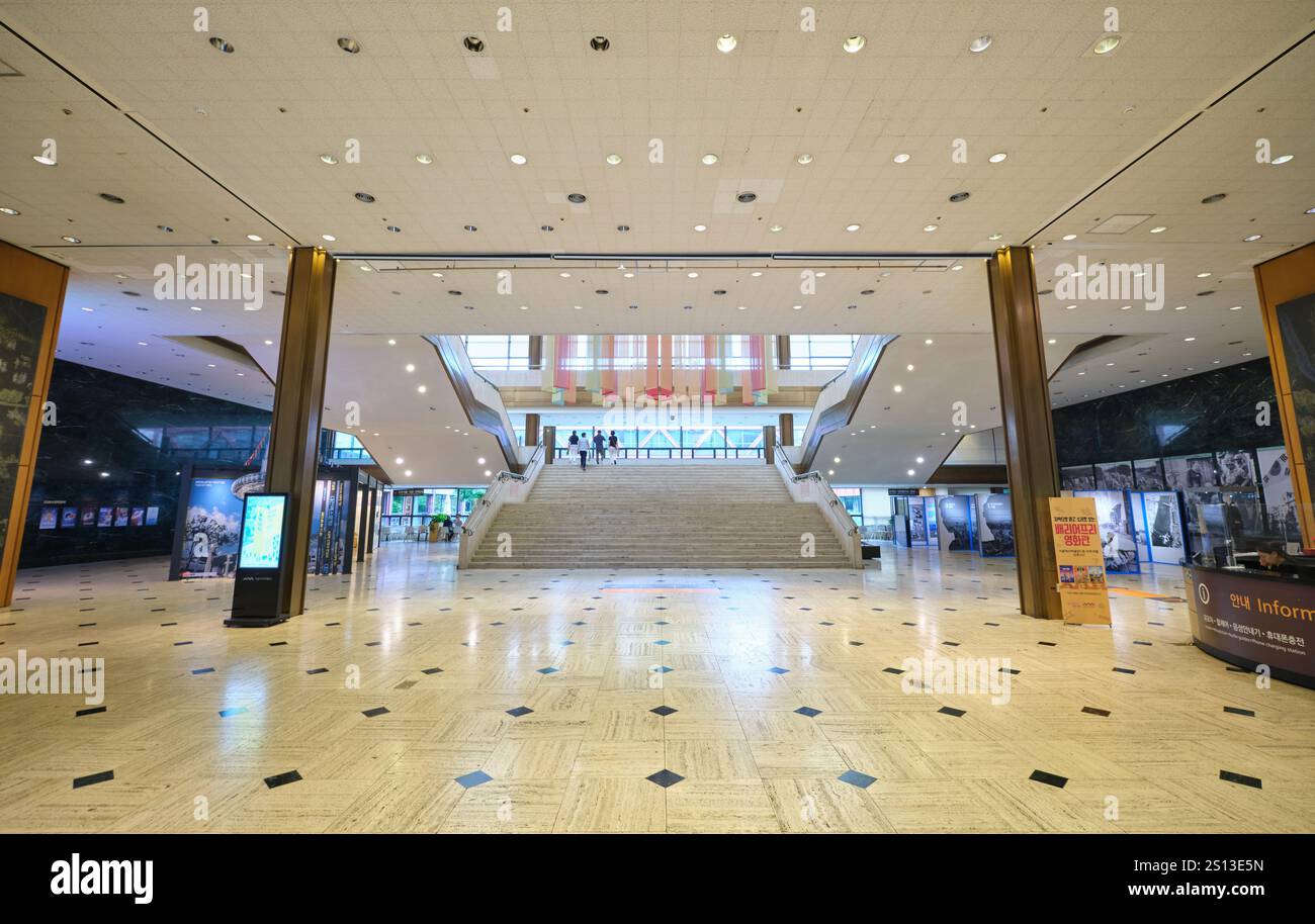 View of the front entrance lobby with big, grand staircase, steps. At ...
