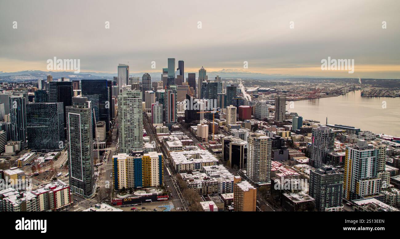 A dense cluster of skyscrapers forms a dynamic cityscape, with snowy ...