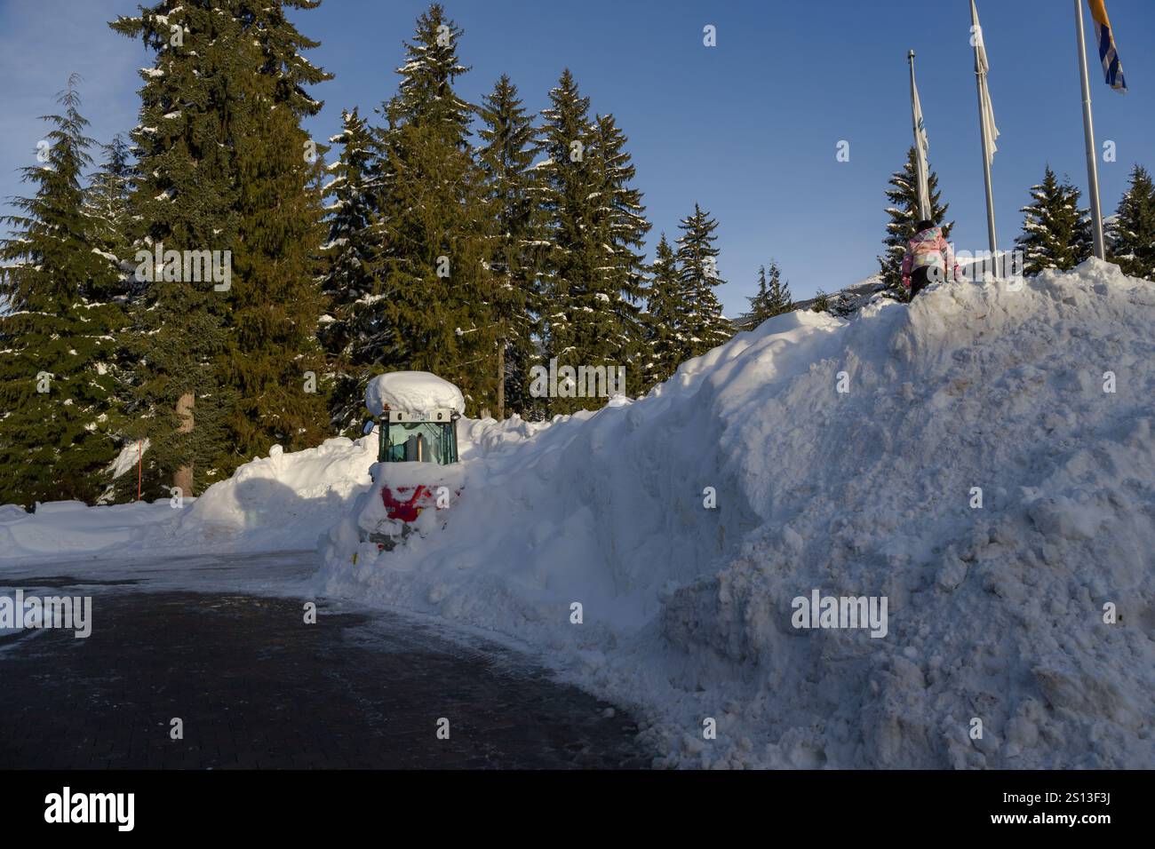 Snow plow tractor under piles of snow. After a blizzard - a transport ...