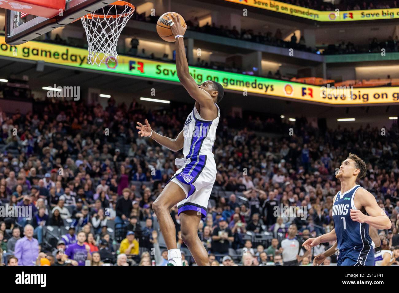 Sacramento Kings guard De'Aaron Fox, left, makes a layup on a fast ...