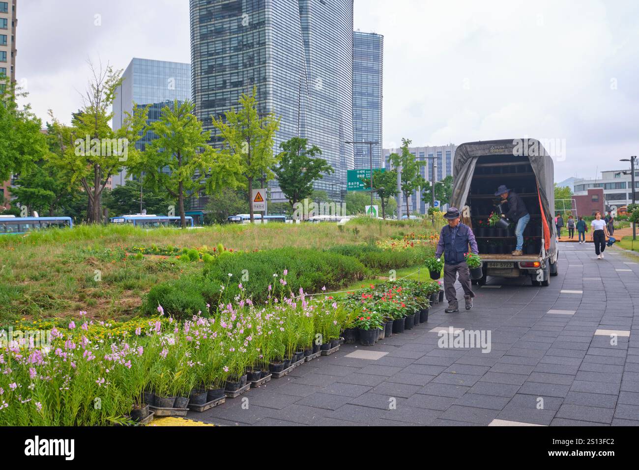 Workers busy with plants, flowers, prepping for the show. At the ...