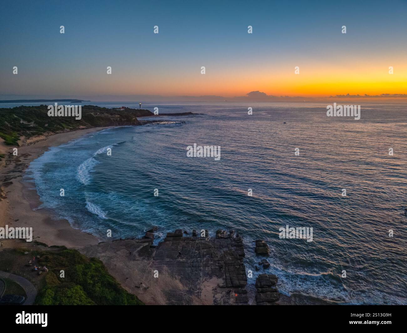 Aerial sunrise over the sea from Soldiers Beach at Norah Head, NSW ...