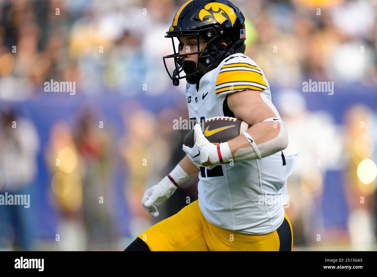 Wide receiver Kaden Wetjen (Iowa Hawkeyes, #21) carries the ball on a ...