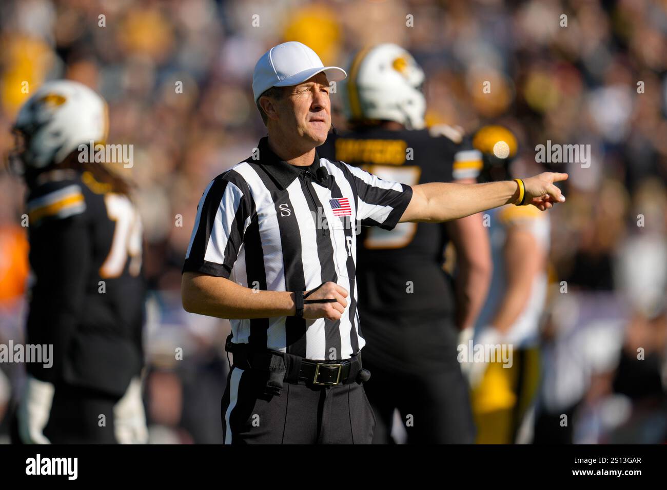 Referee Mike Roche signals after a penalty call. USA, Iowa Hawkeyes vs ...