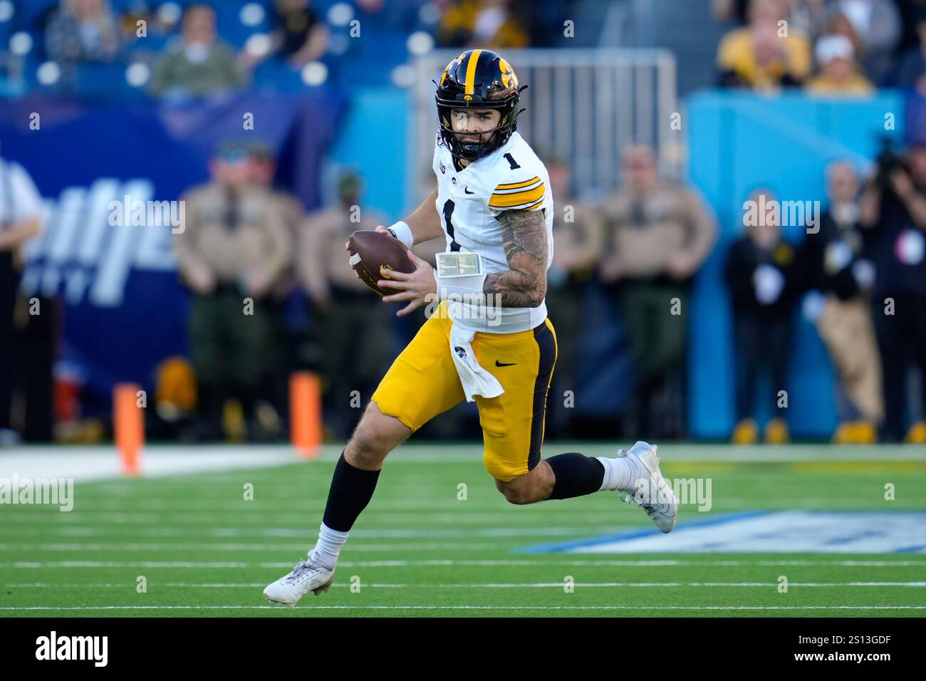 Quarterback Brendan Sullivan (Iowa Hawkeyes, #01) carries the ball for ...