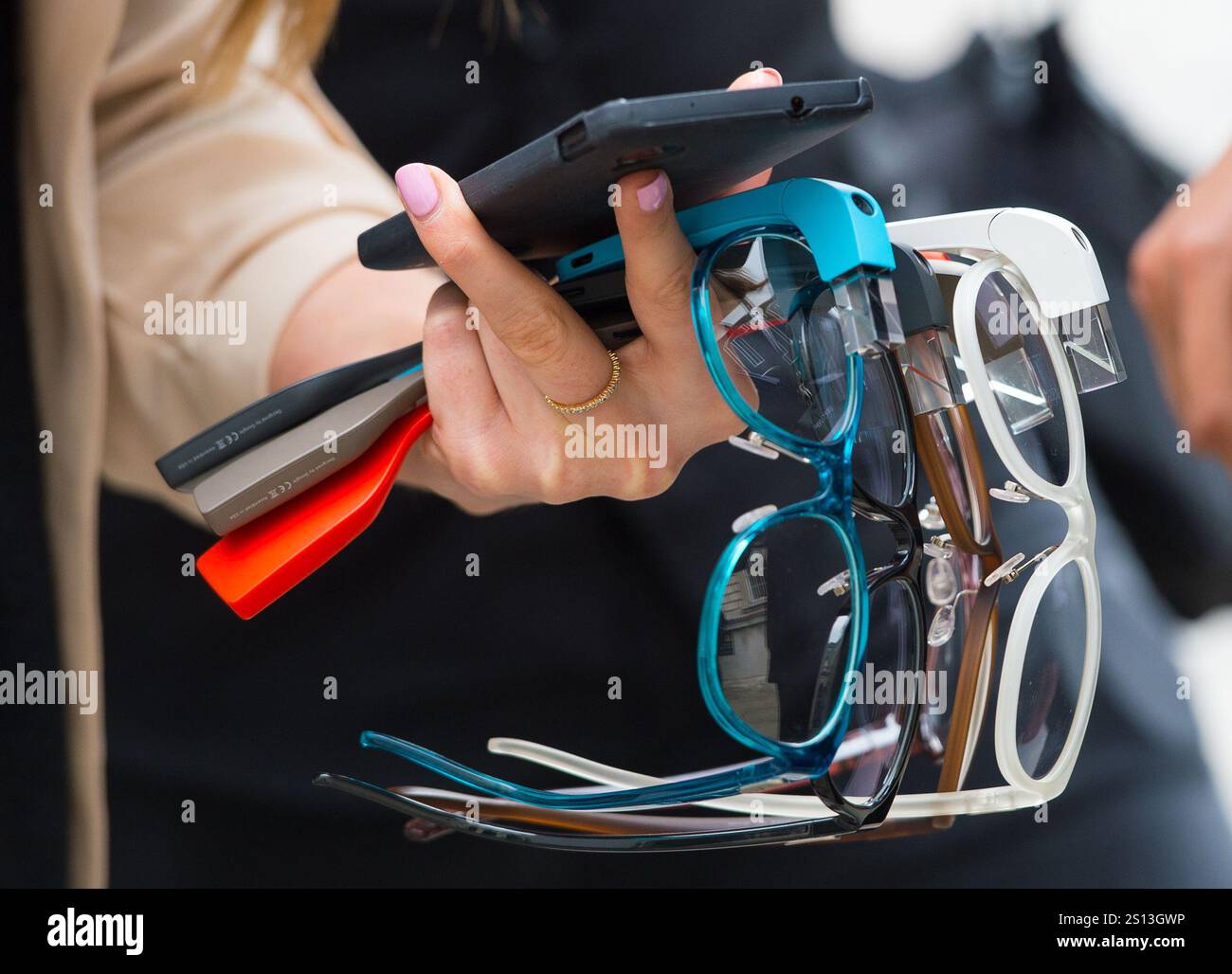 File photo dated 129/2014 of a woman holds a smartphone and several ...