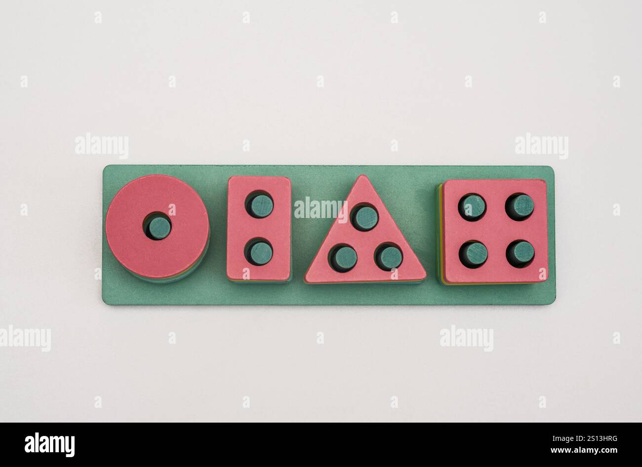 Wooden logic game of shapes with holes - circle, square, triangle ...