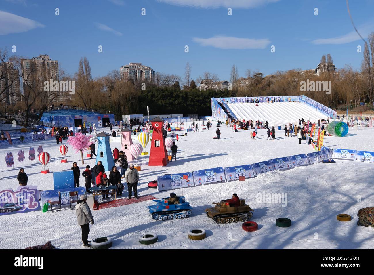 Tourists experience ice and snow sports at a park in Beijing, China, 27 ...