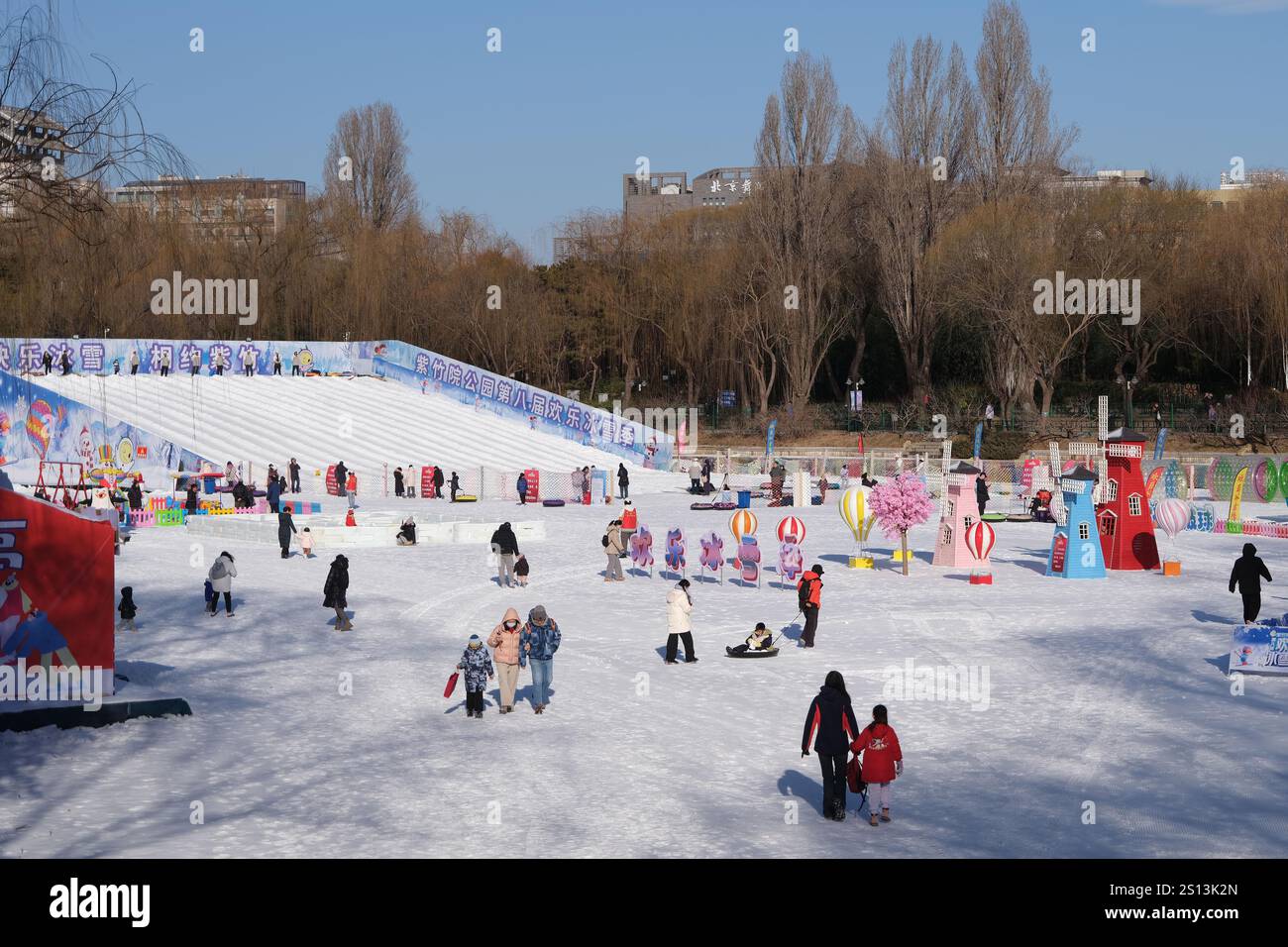 Tourists experience ice and snow sports at a park in Beijing, China, 27 ...