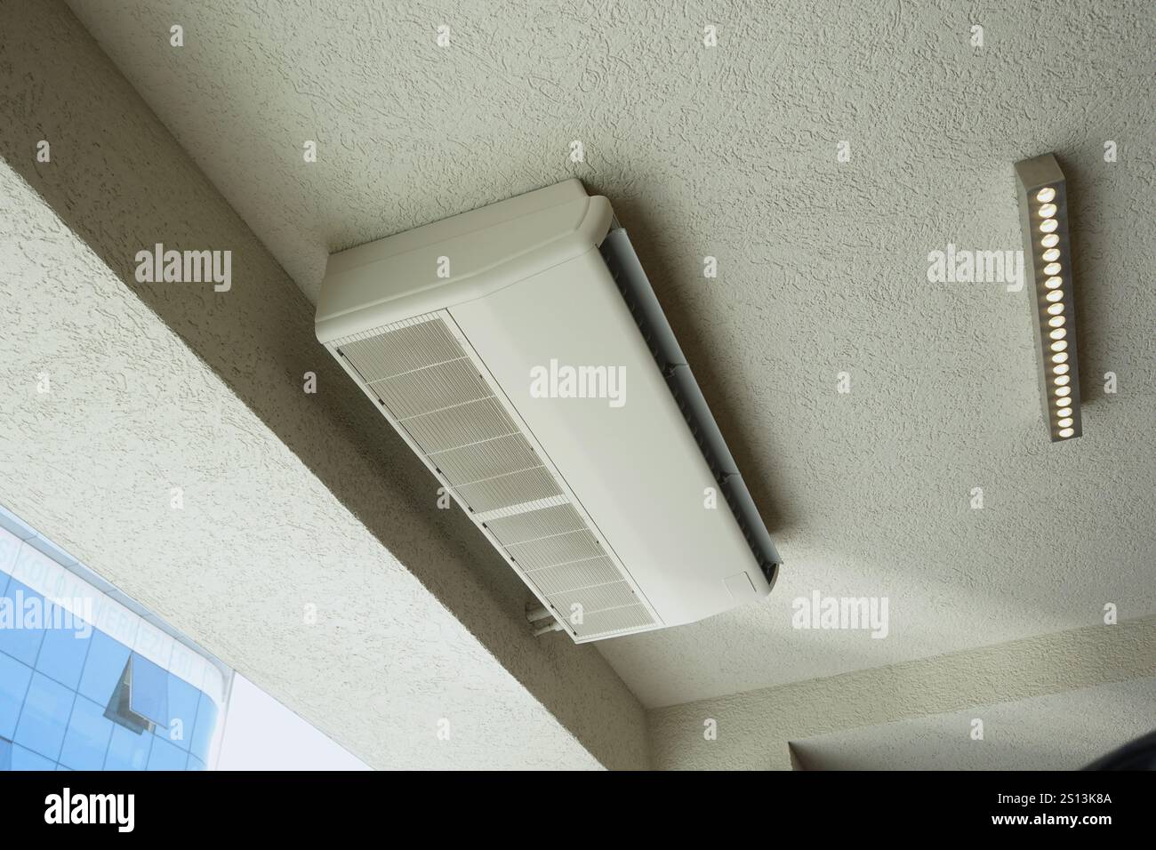 Installation of a modern ceiling air conditioner within the office ...