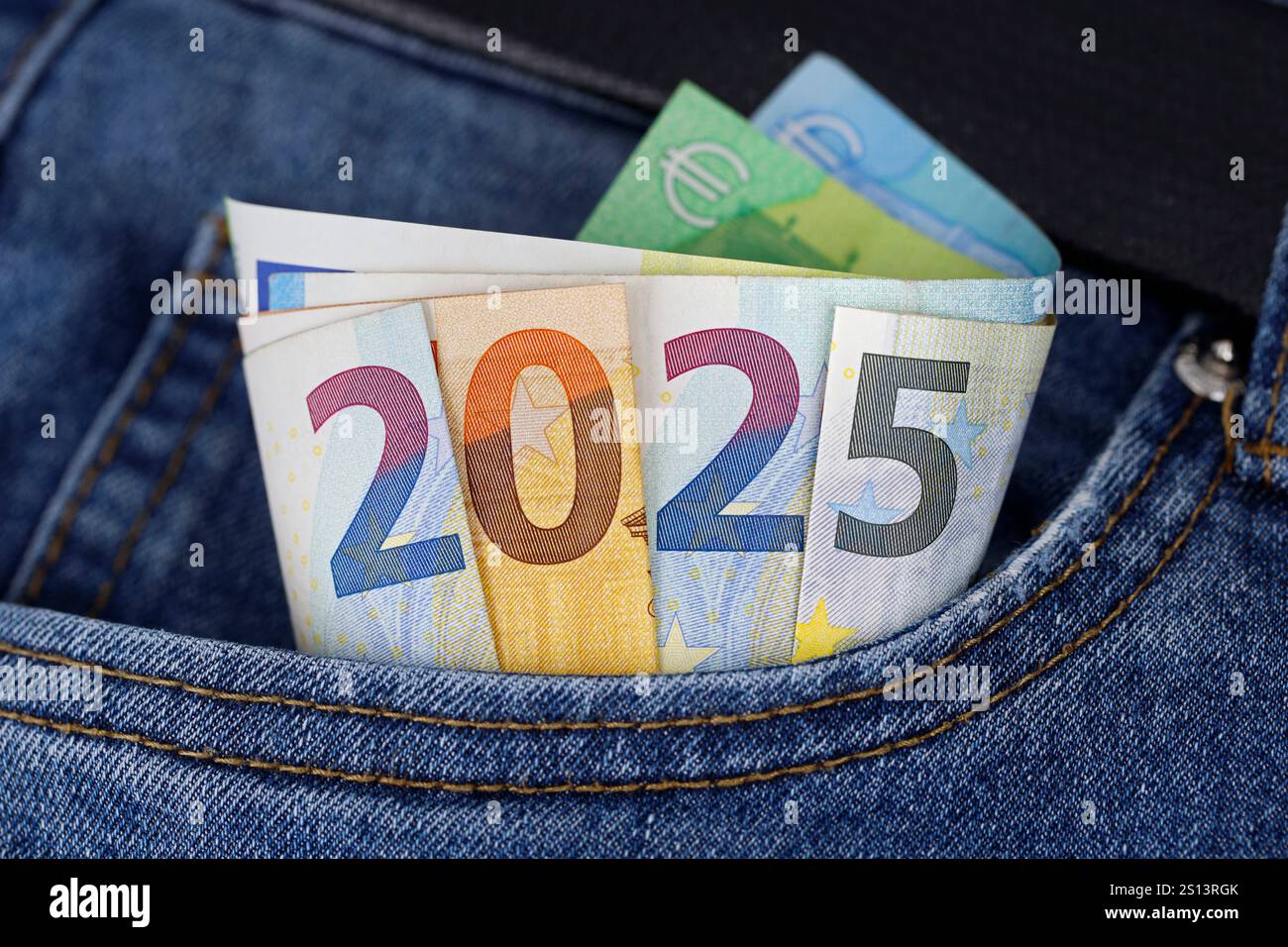 cash in the trouser pocket shows the year 2025, euro banknotes in blue ...