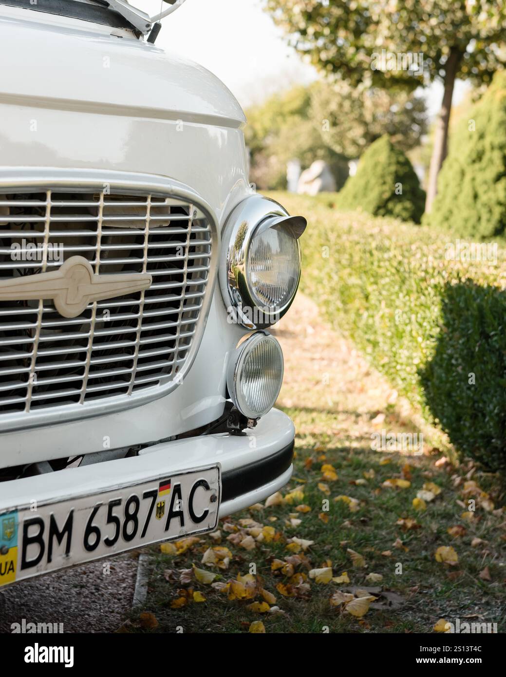 White classic Barkas B1000 van in a park. Front left corner view of old East German minibus ...
