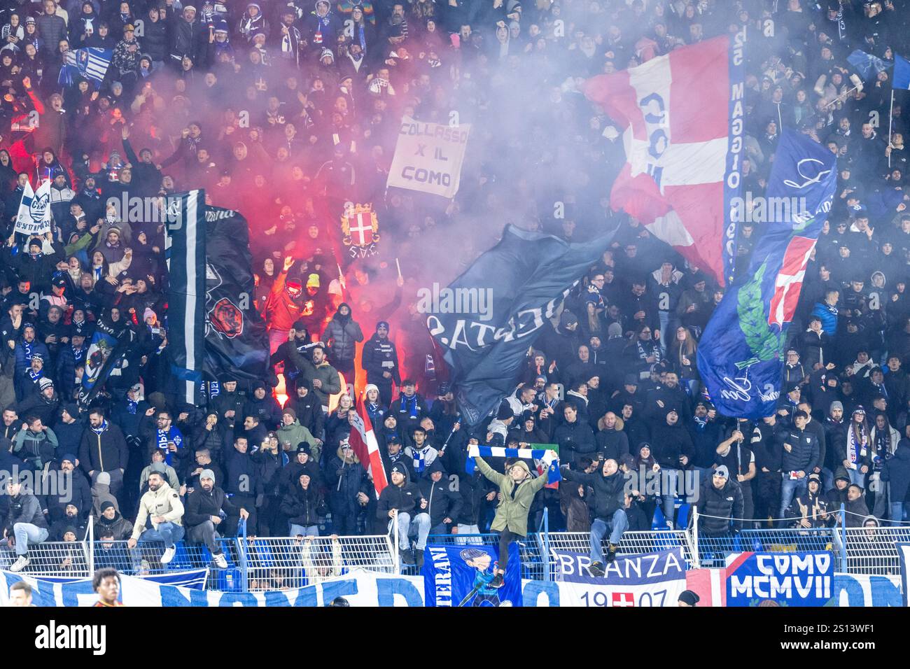 Como, Italy. 30th Dec, 2024. Como supporters supporting team during ...