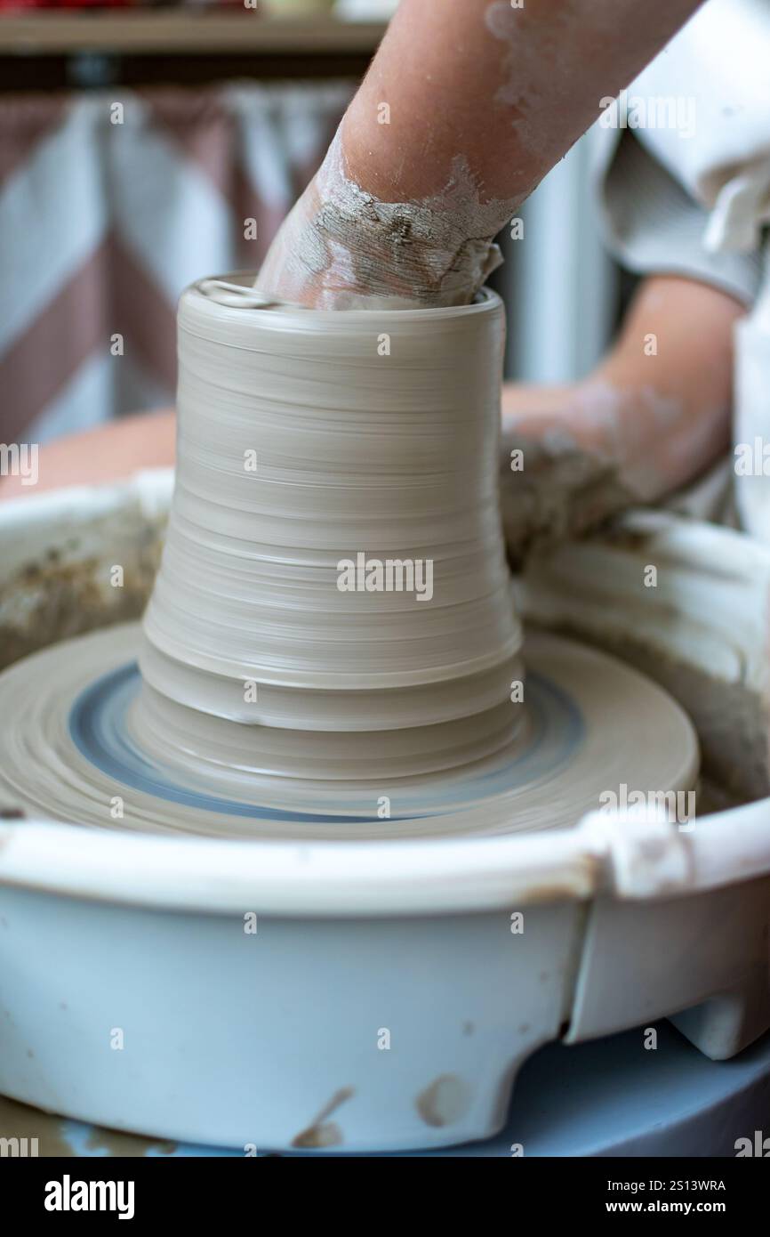 Making of mud pot on potters wheel during workshop in design modern art ...