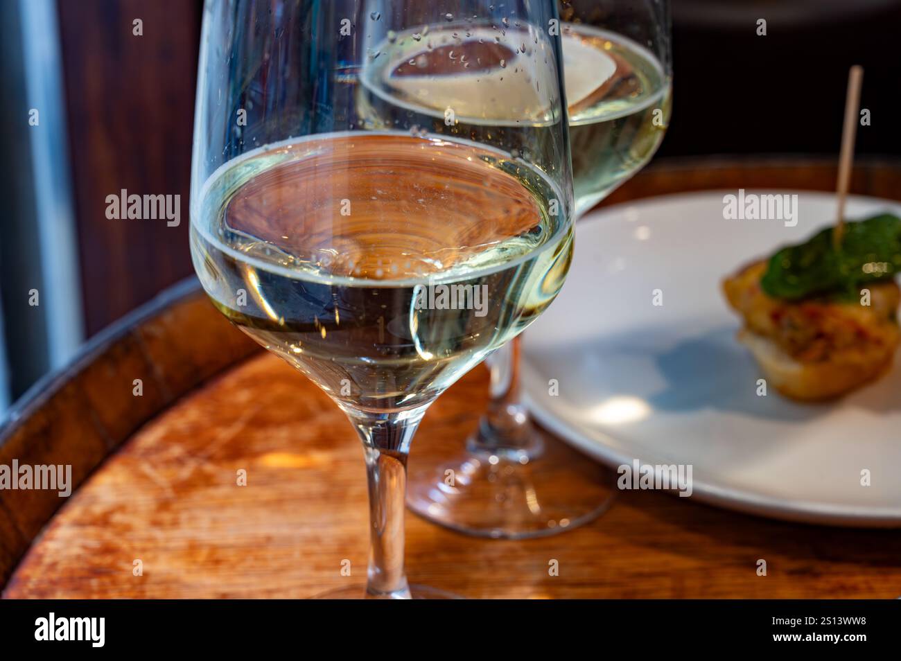 Glasses of txakoli or chacolí slightly sparkling very dry white wine ...