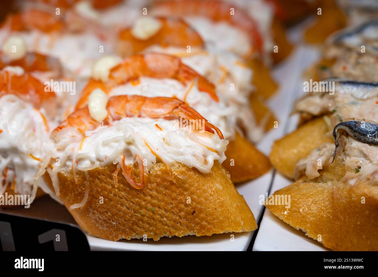 Typical snack of Basque Country, pinchos or pinxtos skewers with small ...