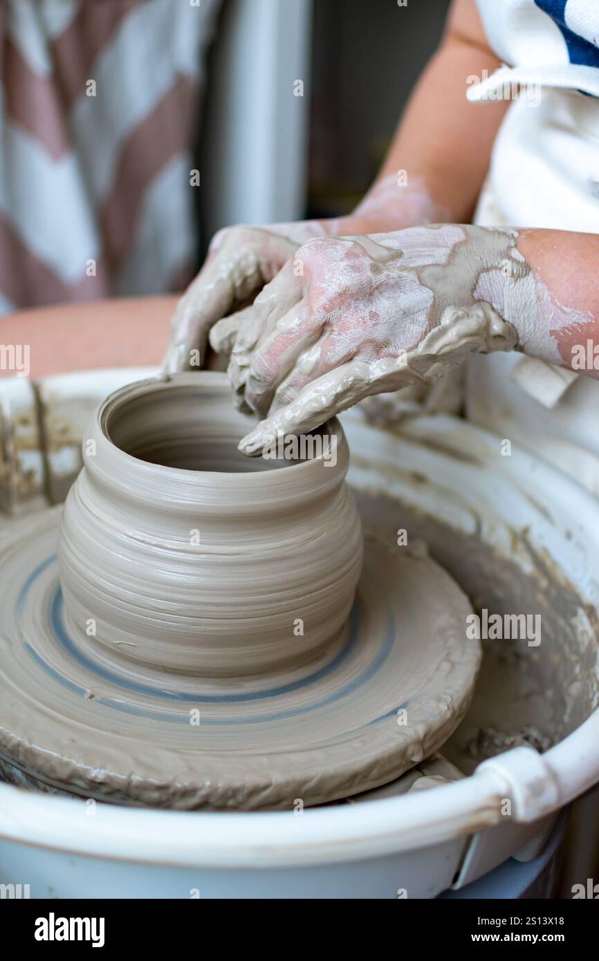 Making of mud pot on potters wheel during workshop in design modern art ...