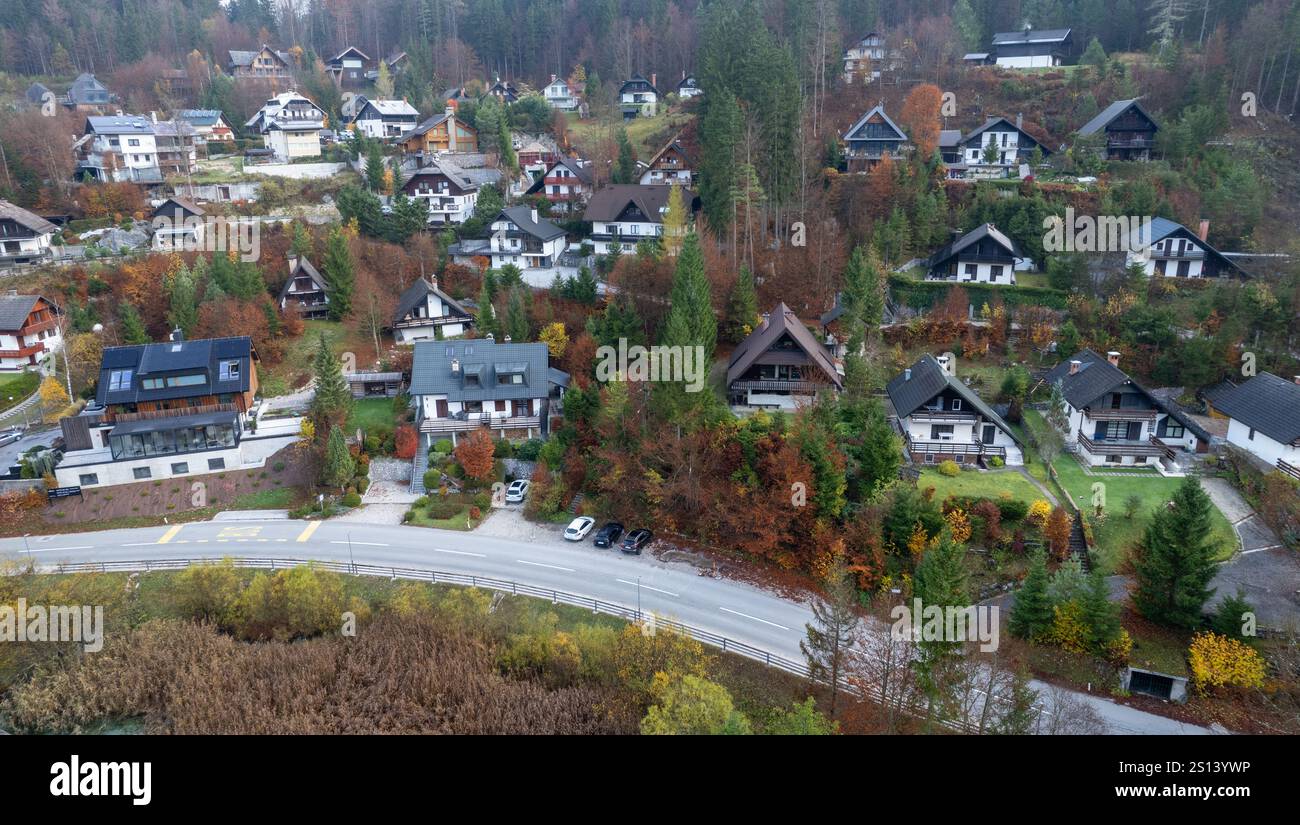 Charming village houses nestled amidst colorful autumn foliage ...