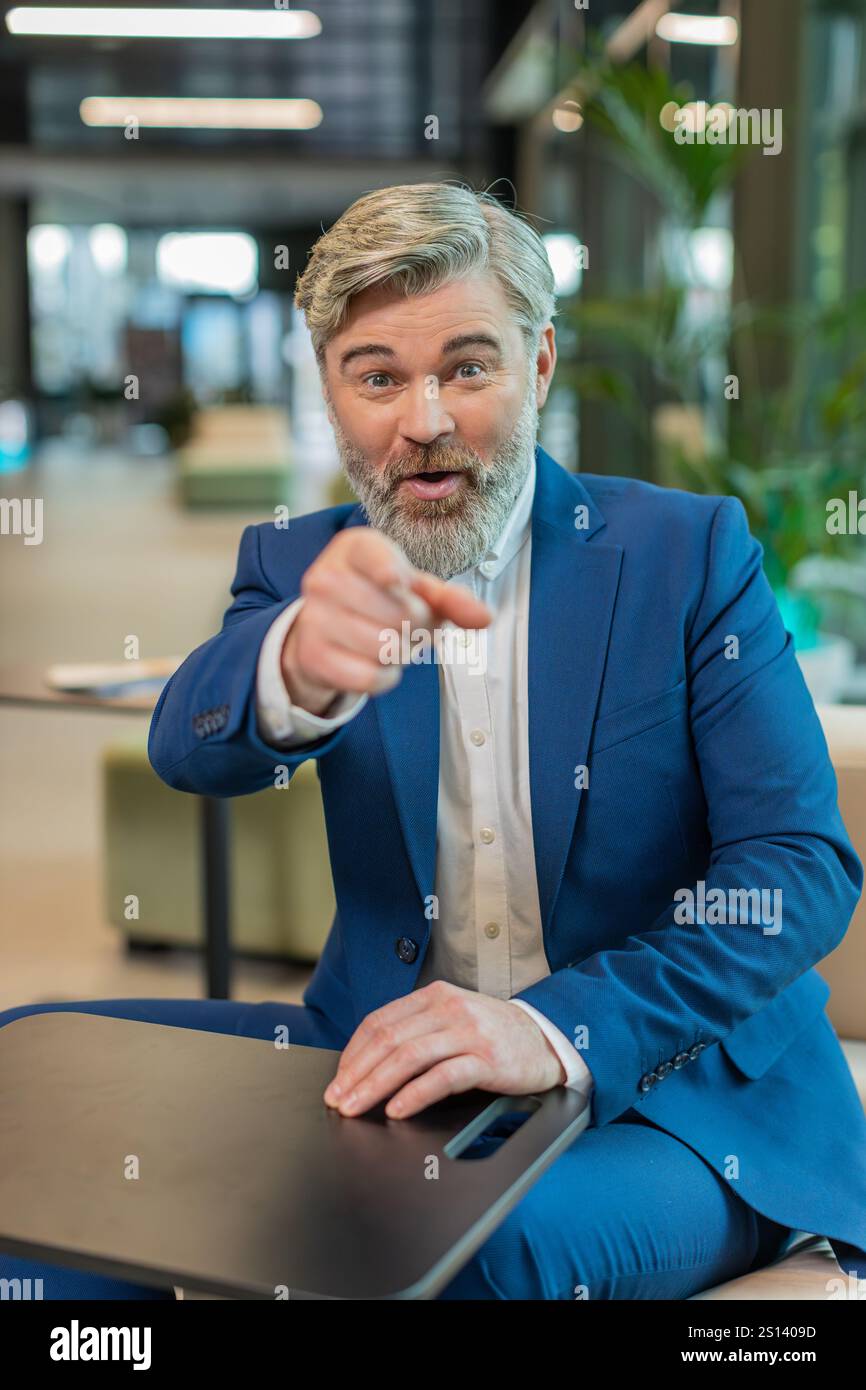 I choose you. Caucasian middle-aged businessman pointing to camera ...