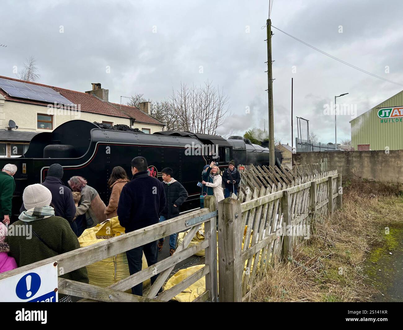 An old restored steam locomotive at Leyburn Station, with a crowd of ...