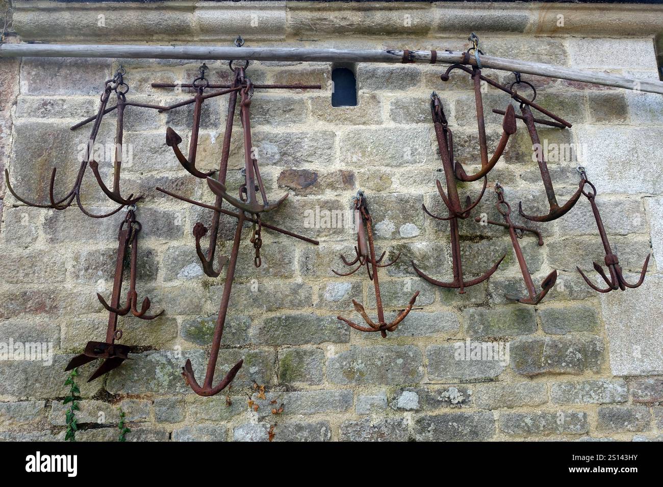 various old rusty anchors on a house wall, France, Brittany Stock Photo ...