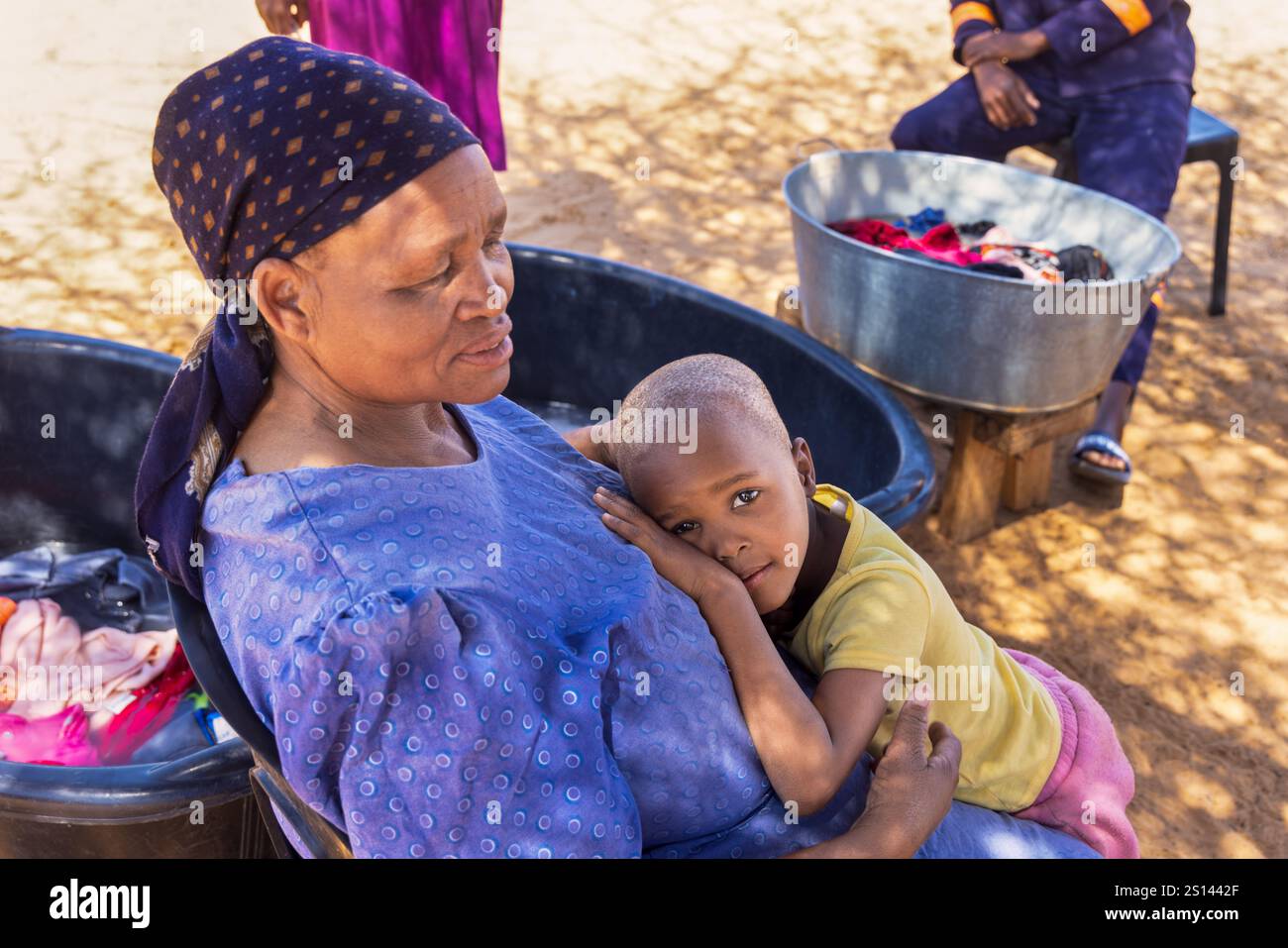 african village , happy smiling loving grandmother hugging child ...