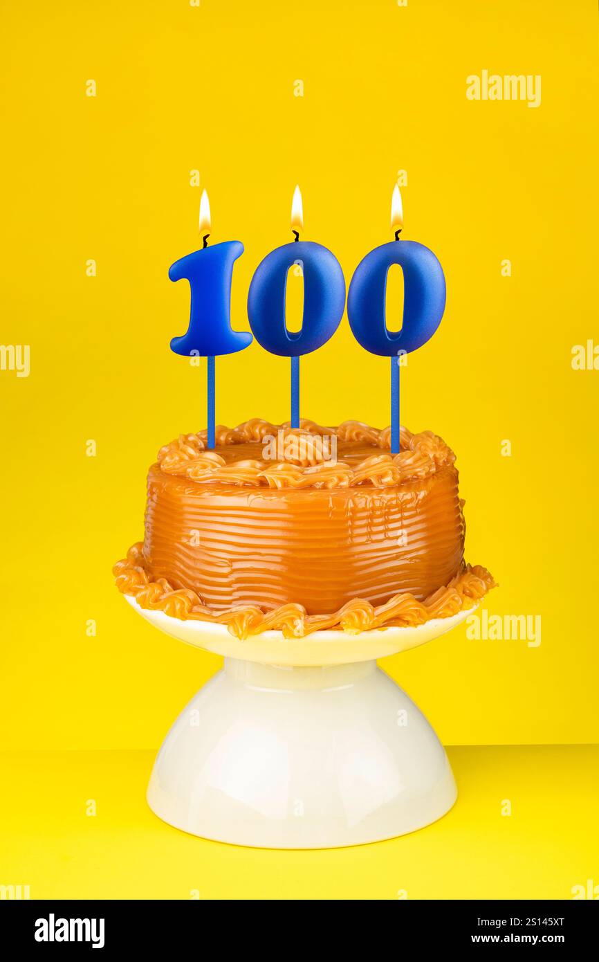 Number 100 candle - Happy Birthday Cake on a yellow background Stock ...