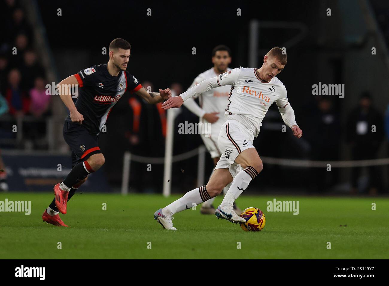 Swansea, UK. 29th Dec, 2024. Jay Fulton of Swansea city (r) in action ...