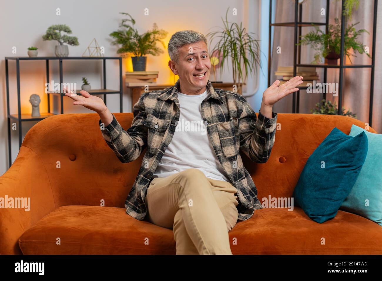 What. Why. Frustrated man with gray hair raising hands in indignant ...