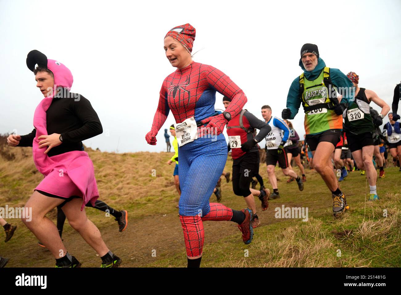 Competitors in fancy dress run across the Pennine tops near Haworth ...