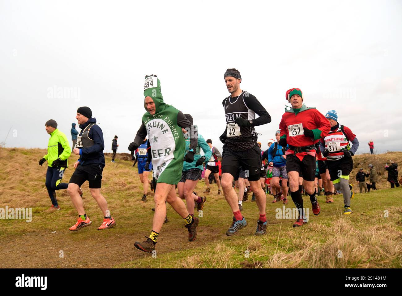 Competitors in fancy dress run across the Pennine tops near Haworth ...