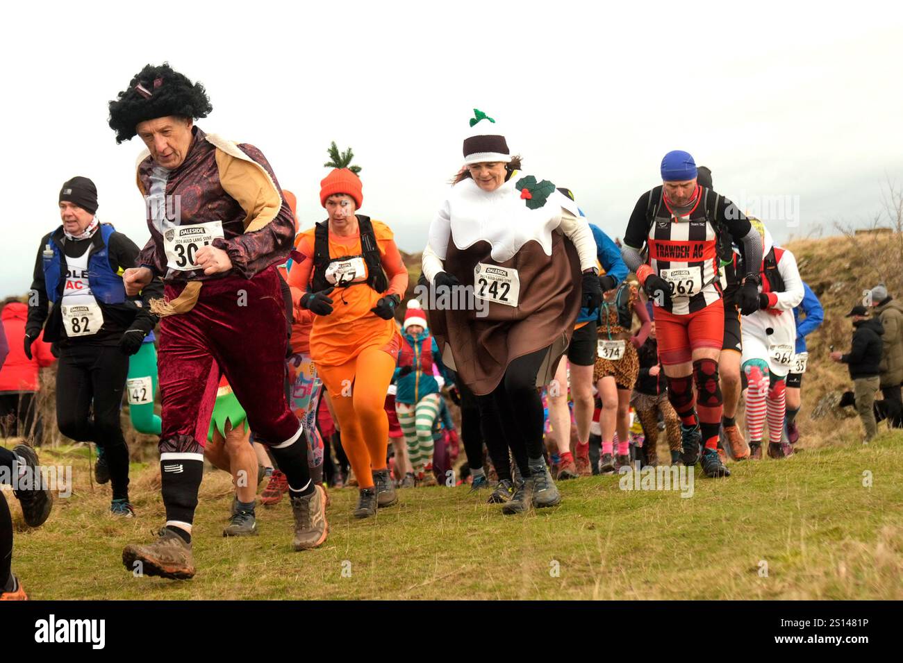 Competitors in fancy dress run across the Pennine tops near Haworth ...