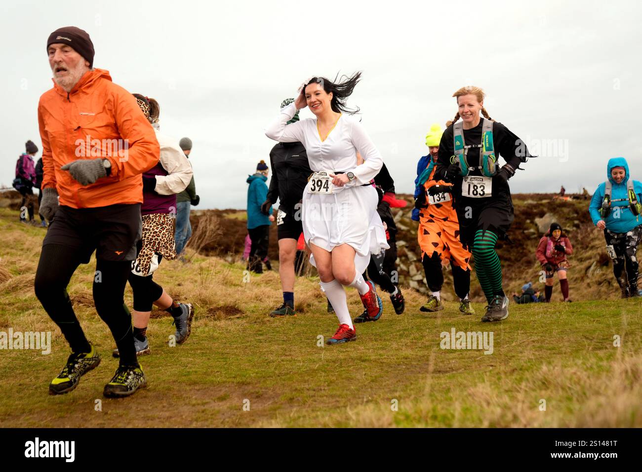 Competitors in fancy dress run across the Pennine tops near Haworth ...