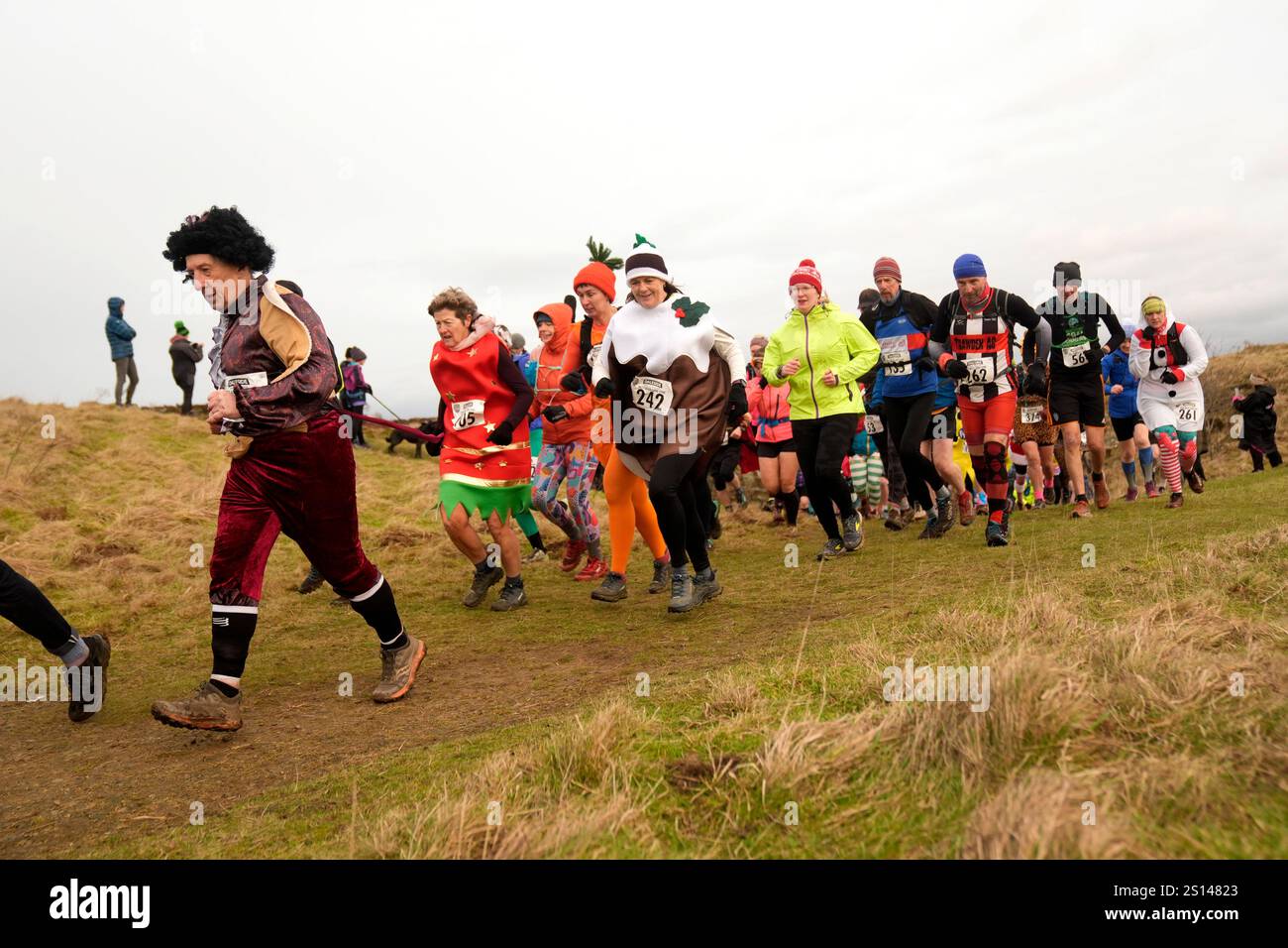 Competitors in fancy dress run across the Pennine tops near Haworth ...