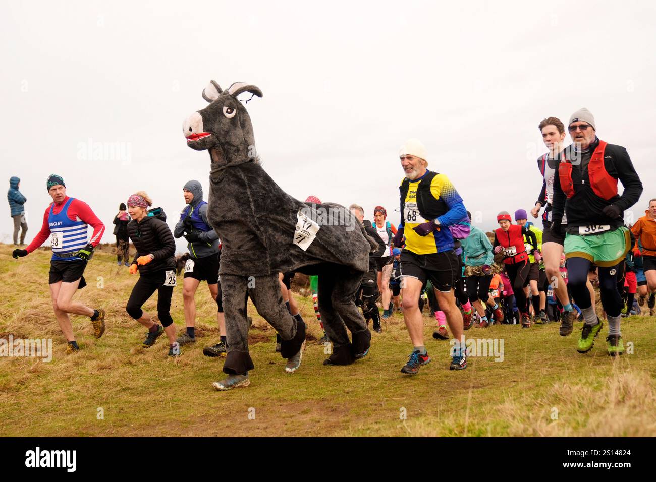 Competitors in fancy dress run across the Pennine tops near Haworth ...