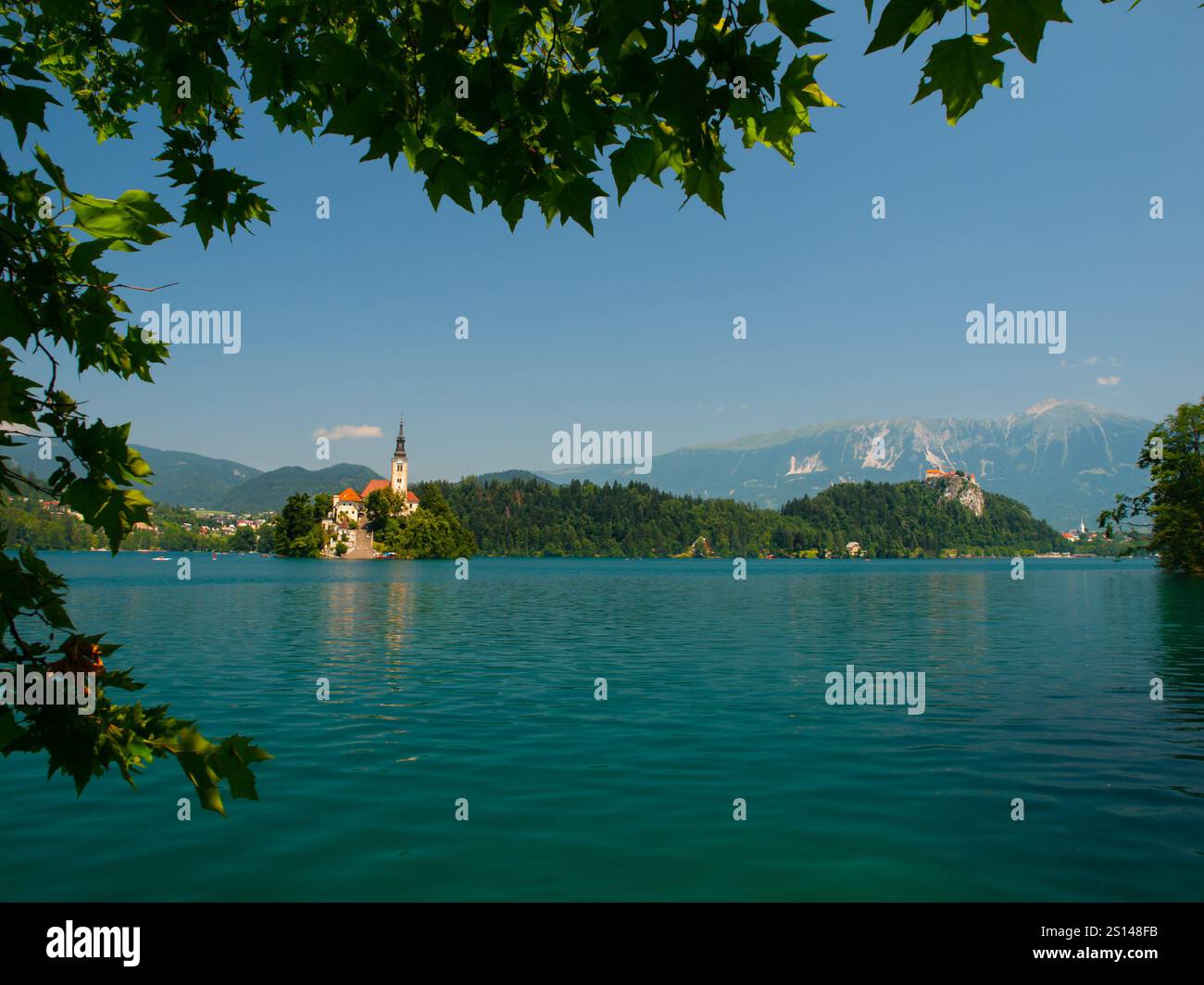 Bled lake with island church and Bled castle, mountains in background ...