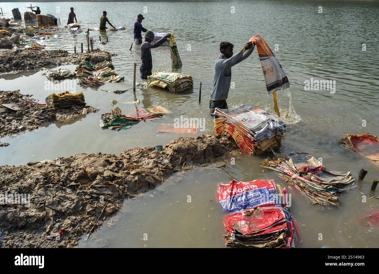Workers are risking their lives to wash cement bags in the water of ...