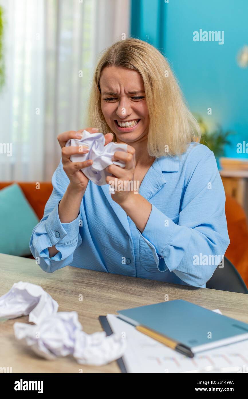Angry furious woman working at home throwing crumpled paper, having ...