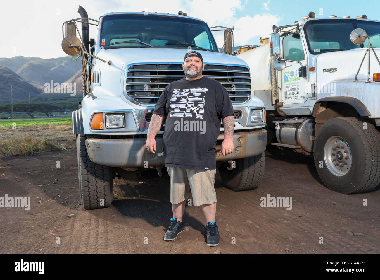 Joshua Kamalo, 43, stands by a truck he drives for work Wednesday, Dec ...