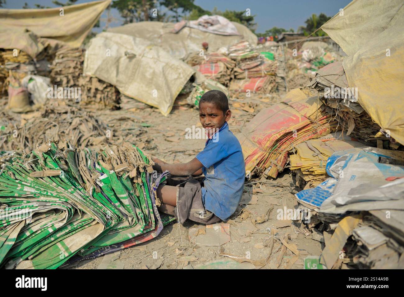 A child worker is risking their life unloading dusty cement bags beside ...