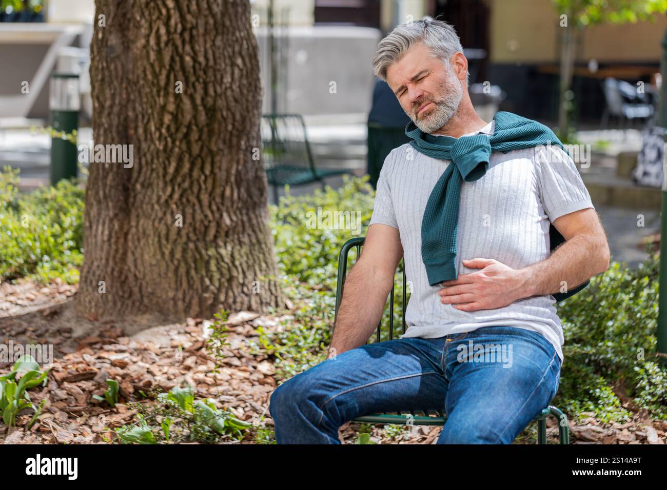 Caucasian mature man feeling sudden strong abdominal stomach ache ...