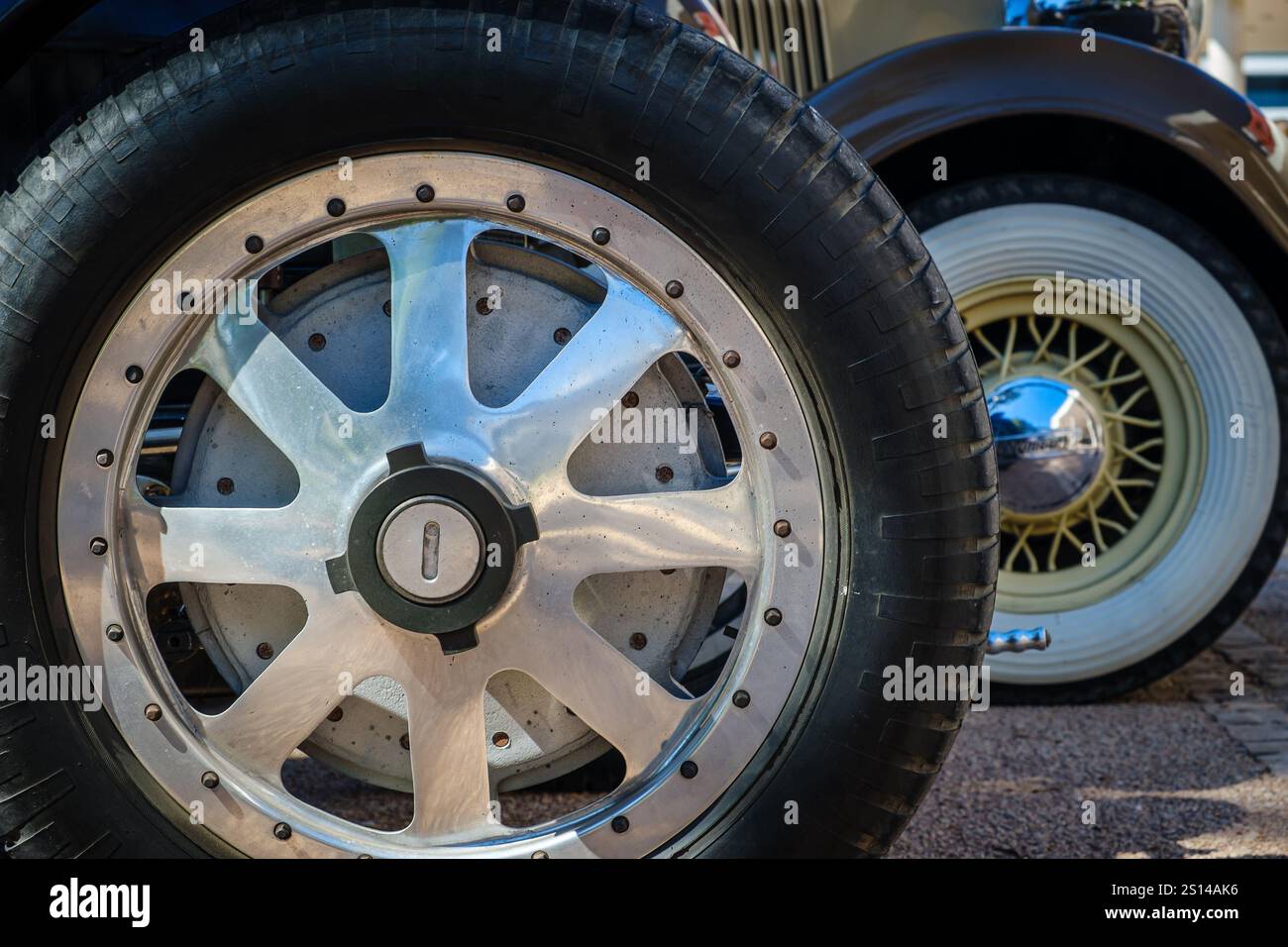 Lisbon, Portugal - Sep 29, 2024: Vintage car wheels on cobblestone road ...