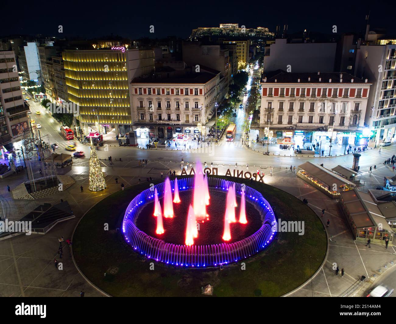 Night view of Omonoia square with colorful fountain, Christmas tree ...