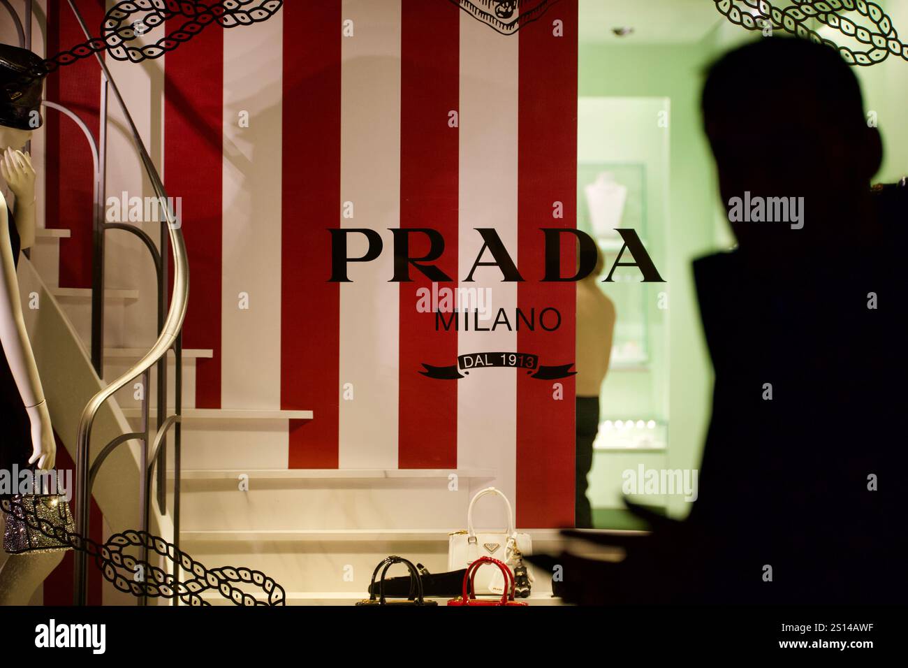 Venice, Italy. December 26, 2024. A man walks by a PRADA storefront ...