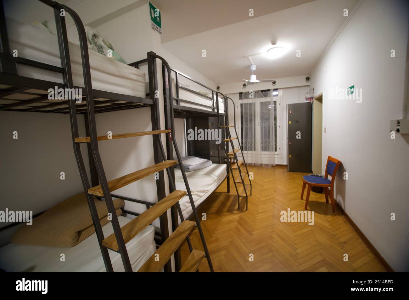 Venice, Italy. December 25, 2024. Inside a hostel, a big room with beds ...