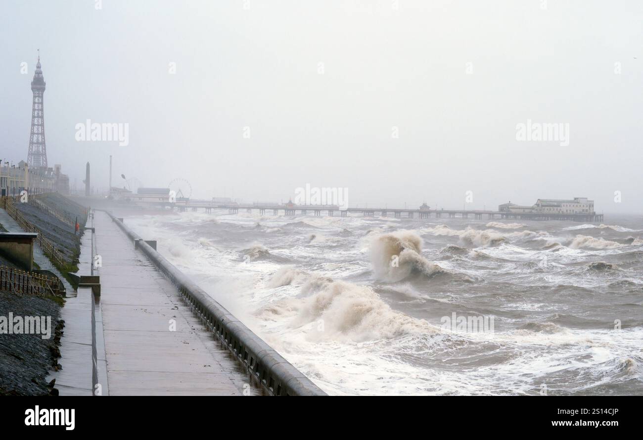 Waves break on the sea front in Blackpool, as snow, rain and wind ...