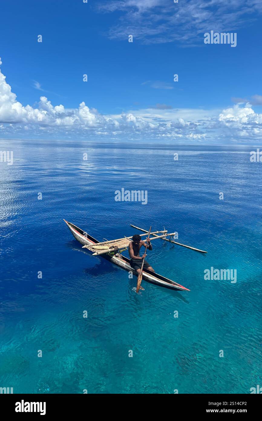 Resident of Vitu Islands in their traditional dugout canoes, Lama ...