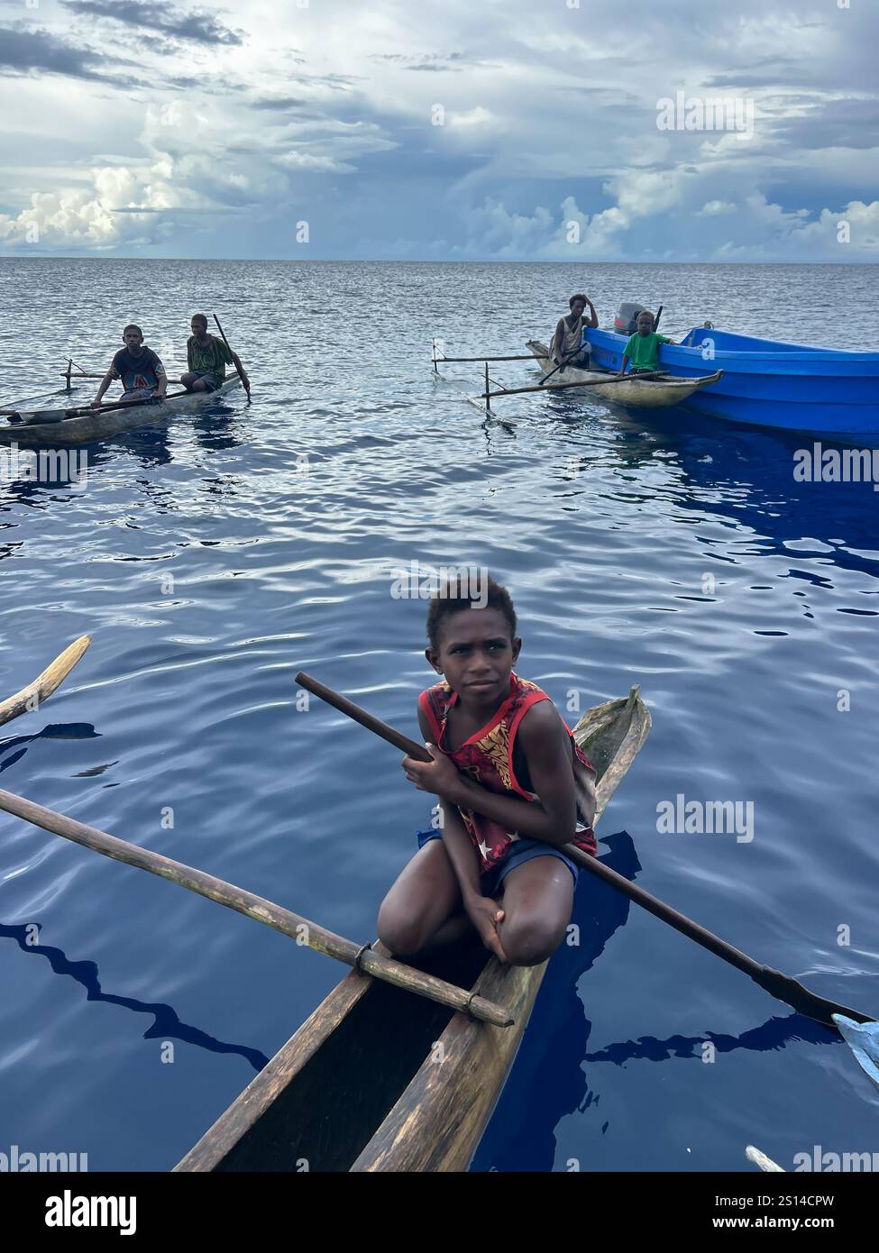 Residents of New Hanover island in their traditional dugout canoes, New ...