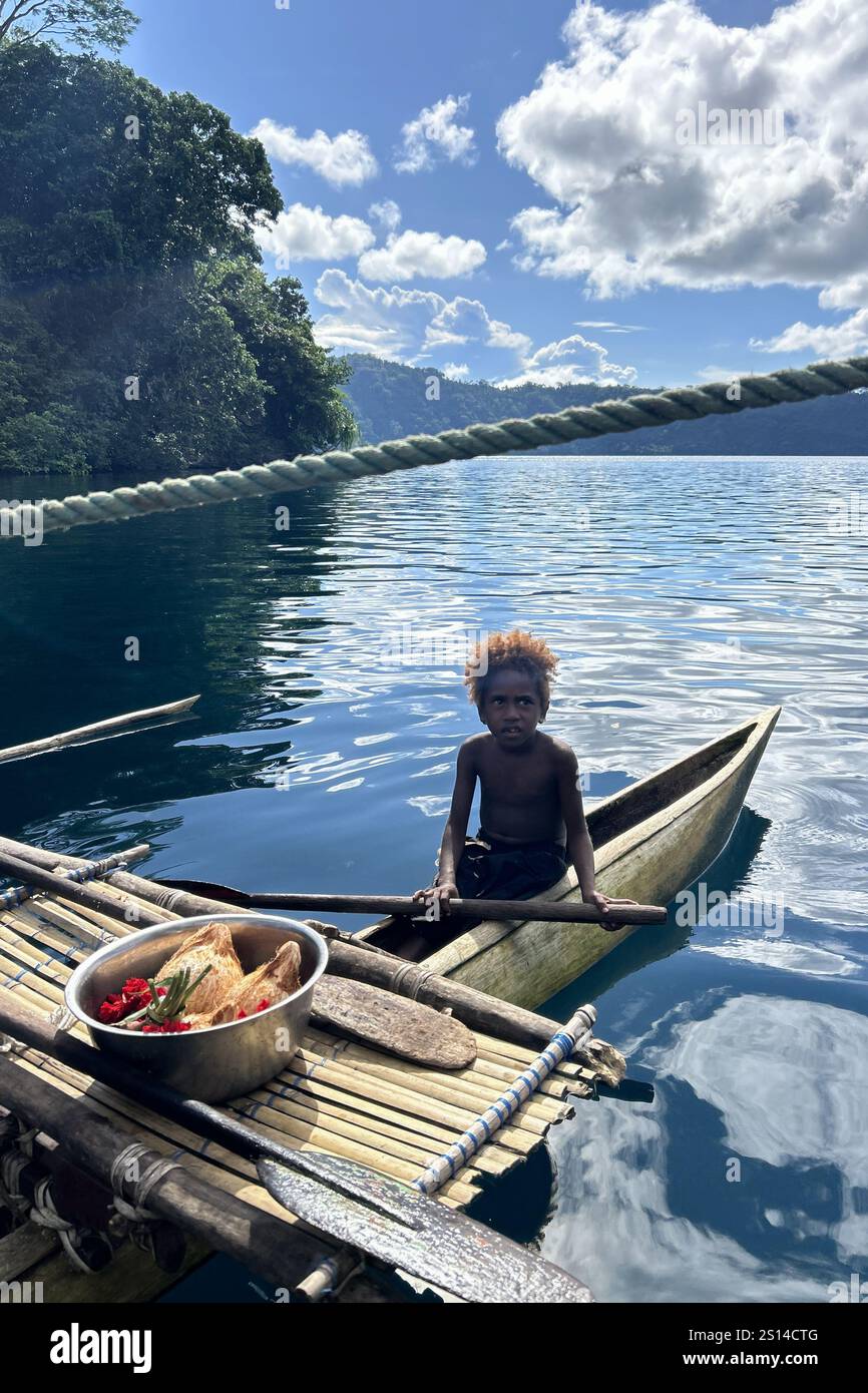 Residents of Vitu Islands in their traditional dugout canoes, Garove ...